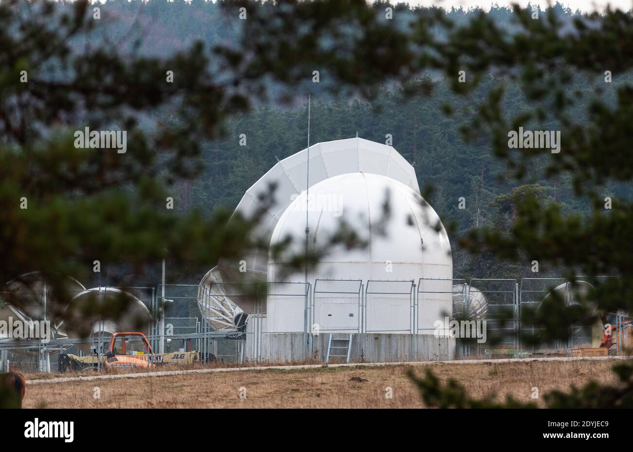 Big satellite dish antennas hidden in green pine tree forest ... Big satellite dish antennas hidden in green pine tree forest ...