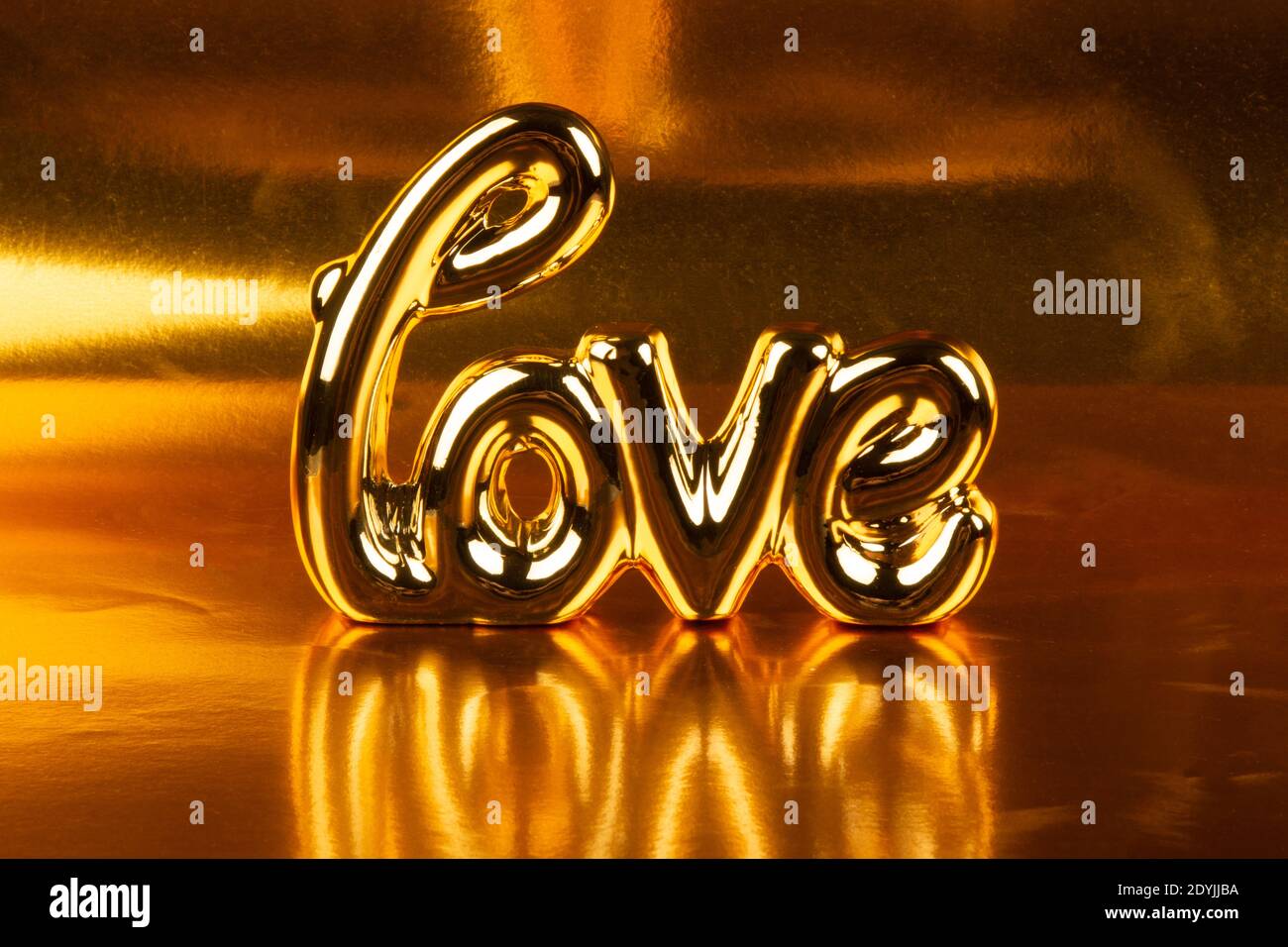 Love text, golden letters with Valentine's day concept Stock Photo - Alamy