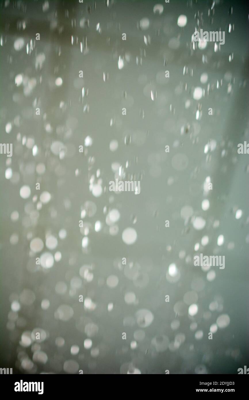 A vertical blurred shot of raindrops falling from the sky Stock Photo ...