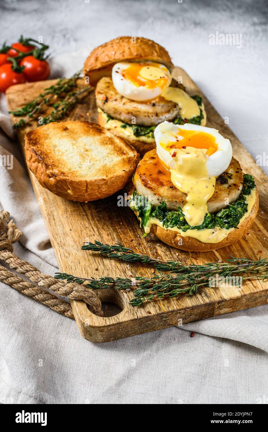 Homemade fish Burger with cod fillet, egg and spinach on a brioche bun ...