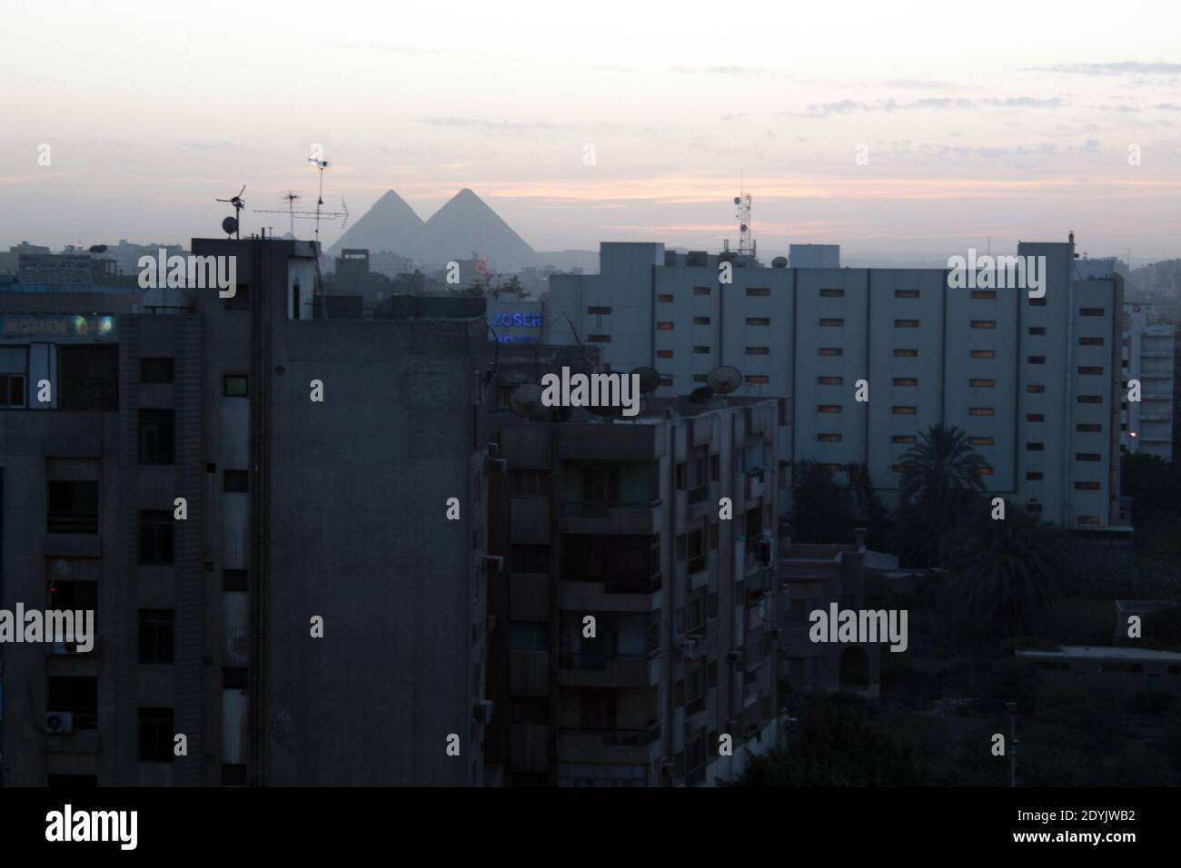 The Cairo town by night with pyramids Stock Photo - Alamy