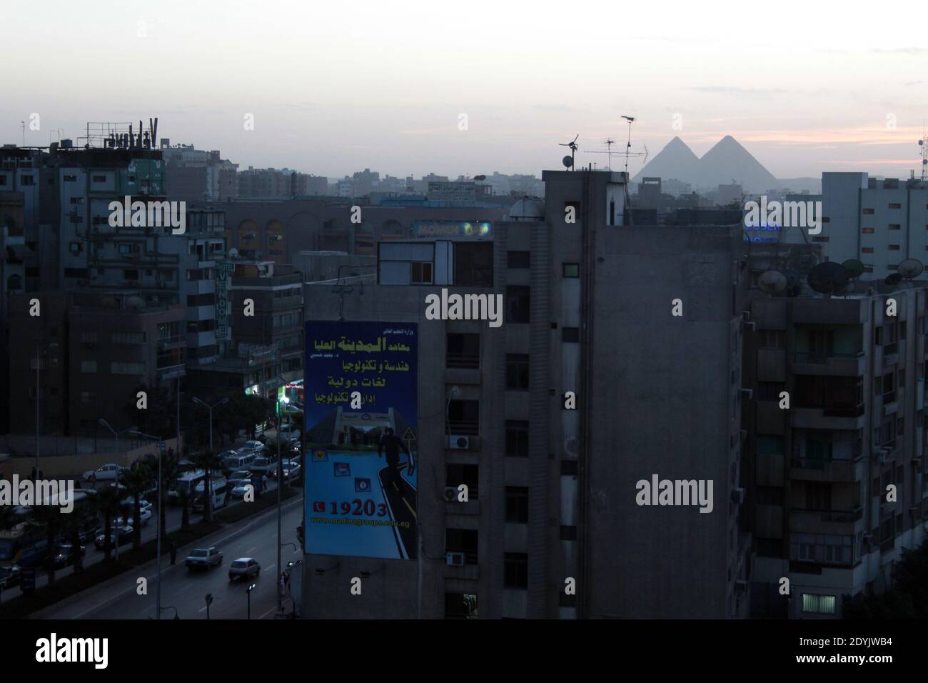 The town Cairo by night with pyramids Stock Photo - Alamy