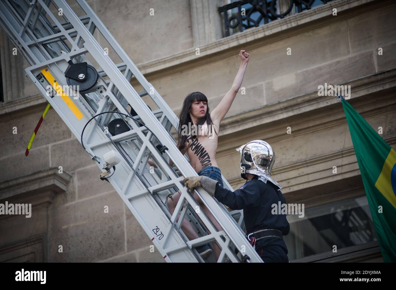 Members of women's rights movement Femen display a banner reading ...