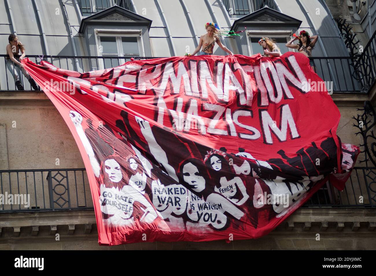 Members of women's rights movement Femen display a banner reading ...