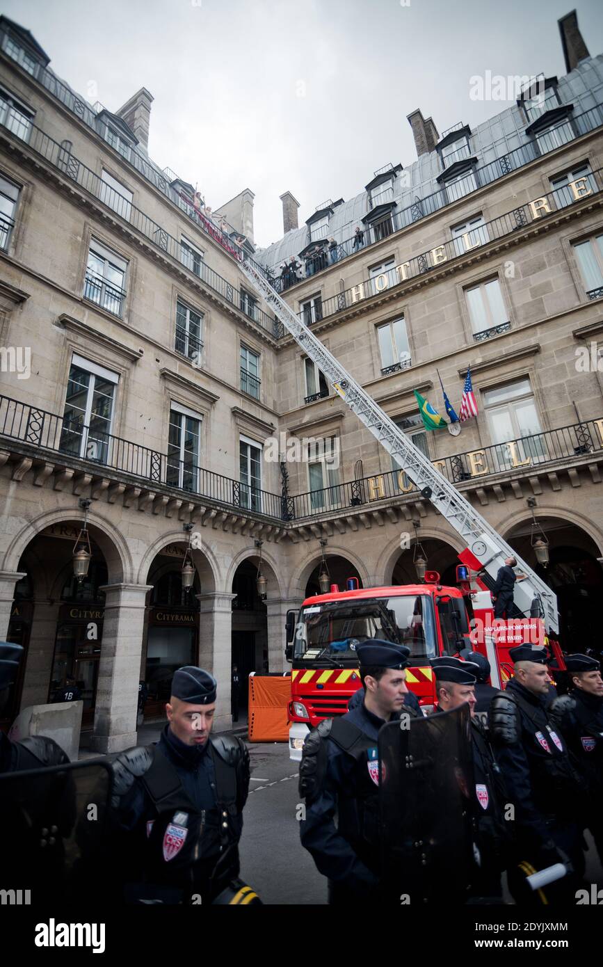 Members of women's rights movement Femen display a banner reading ...