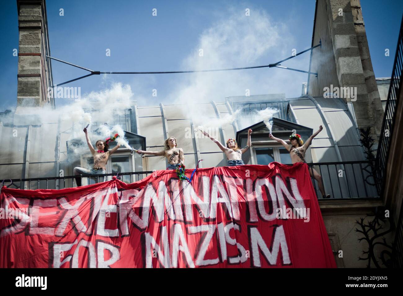Members of women's rights movement Femen display a banner reading ...