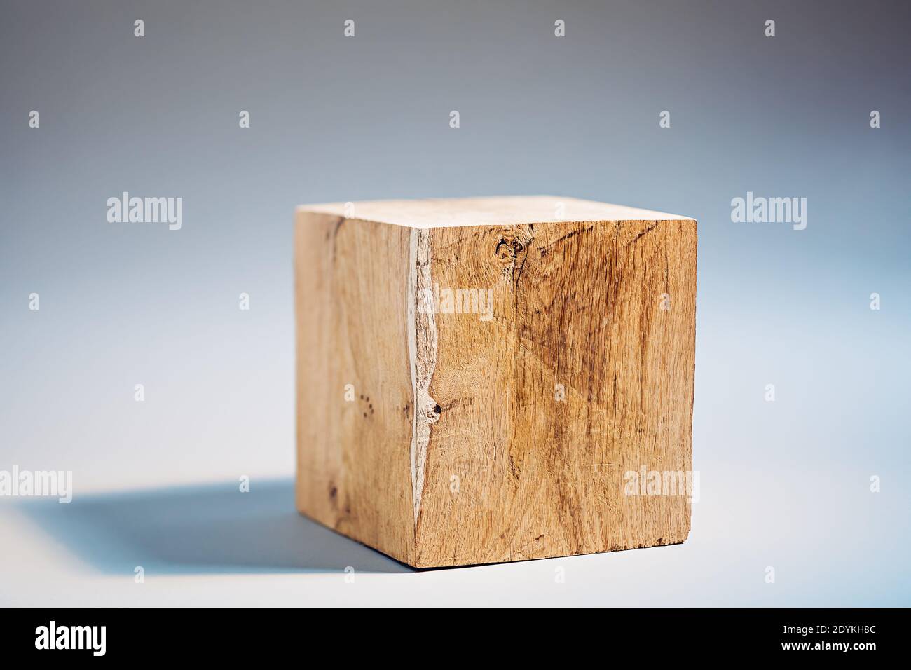 Solid oak cube on a gray background. Very shallow depth of field Stock ...