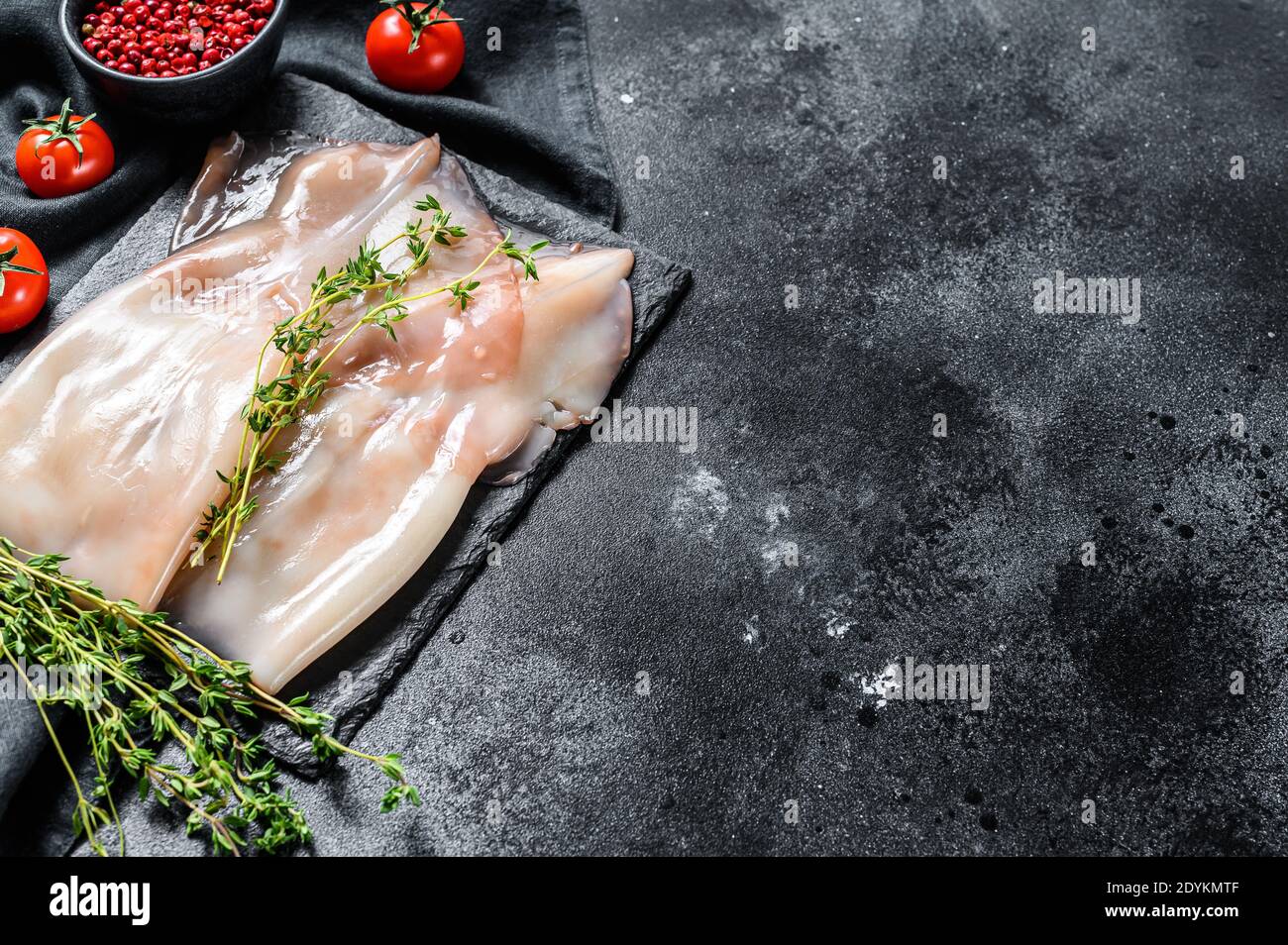Fresh raw whole squid. Black background. Top view. Copy space Stock ...