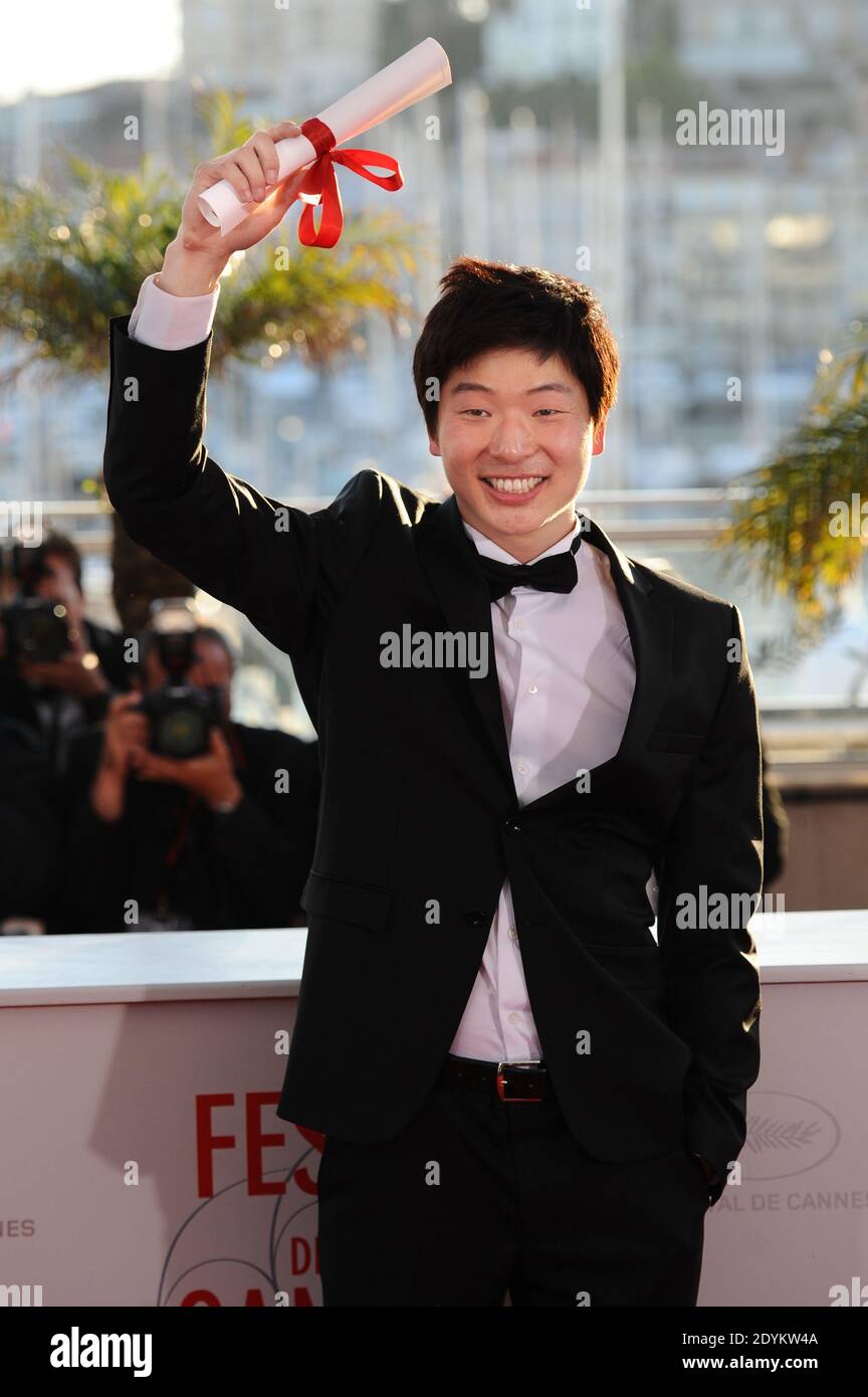 Director Moon Byung-gon poses with the 'Palme d'Or' for the film 'Safe ...