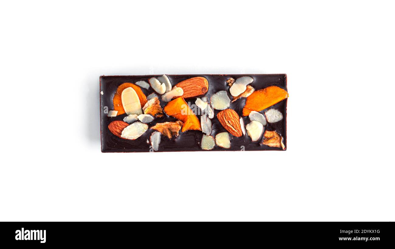 Raw chocolate bar with dried fruits and nuts on a white background ...