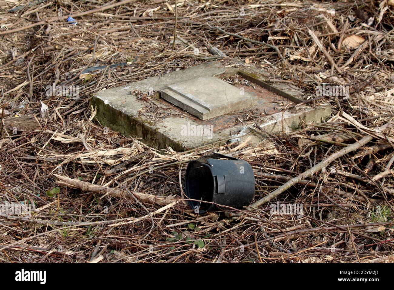 Rarely used abandoned old manhole with concrete foundation and rusted ...