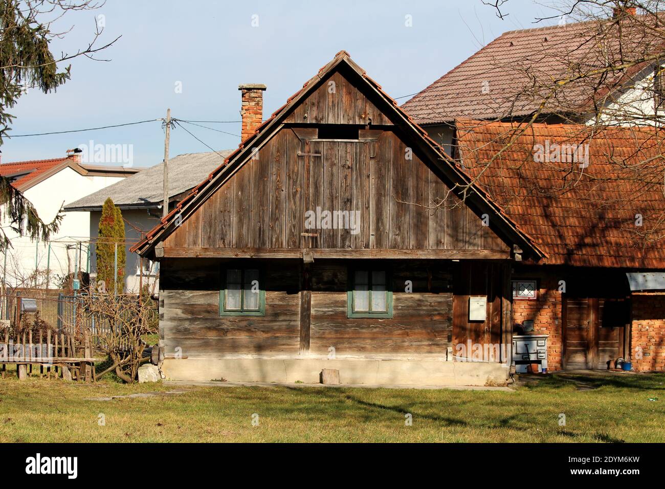Side view of small old wooden family house with green frame windows ...