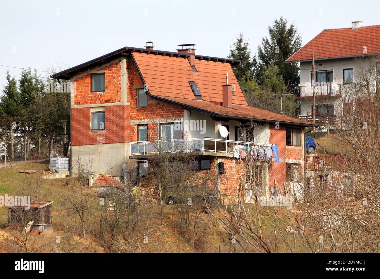 Unfinished red building block suburban family house with large open ...