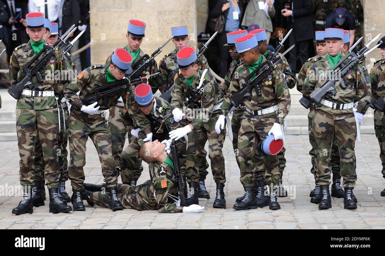 A soldier fainted.French President Francois Hollande and the government ...