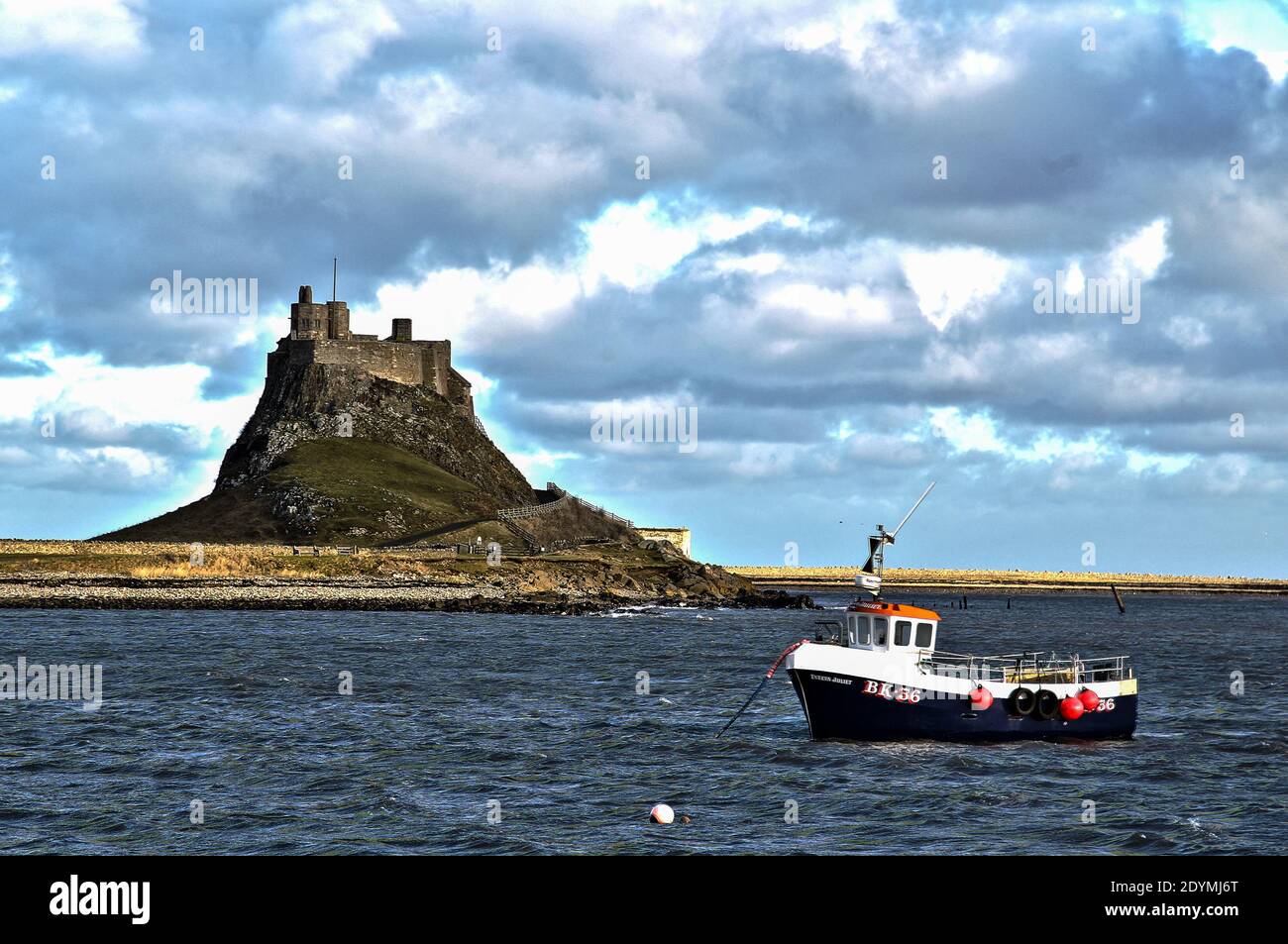 The castle and harbor at Holy Island Stock Photo - Alamy