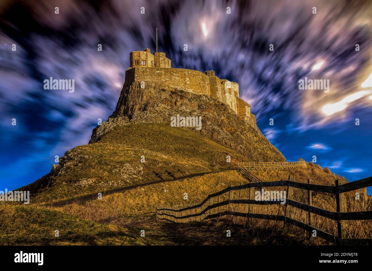 The castle and harbor at Holy Island Stock Photo - Alamy