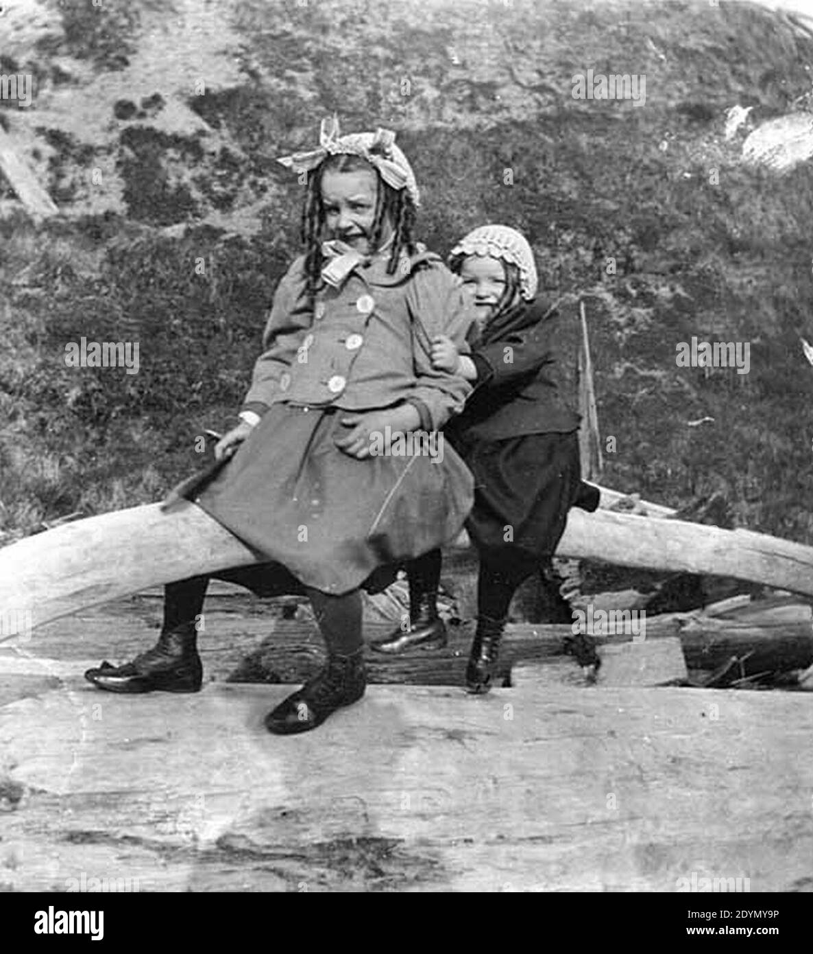 Laura and Miriam Kiehl on log at the beach probabaly below Fort Lawton ...