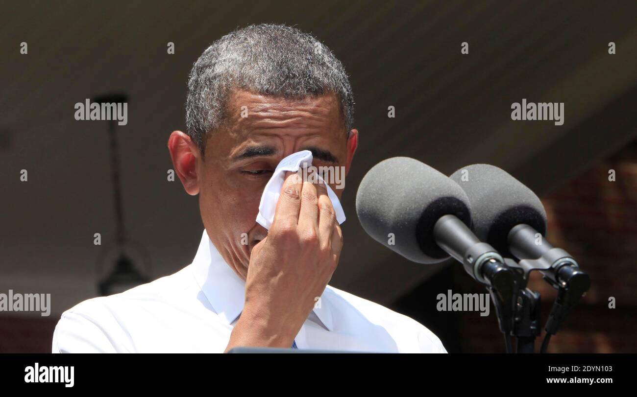 President Barack Obama wipes his face on a hot summer day as he makes a ...