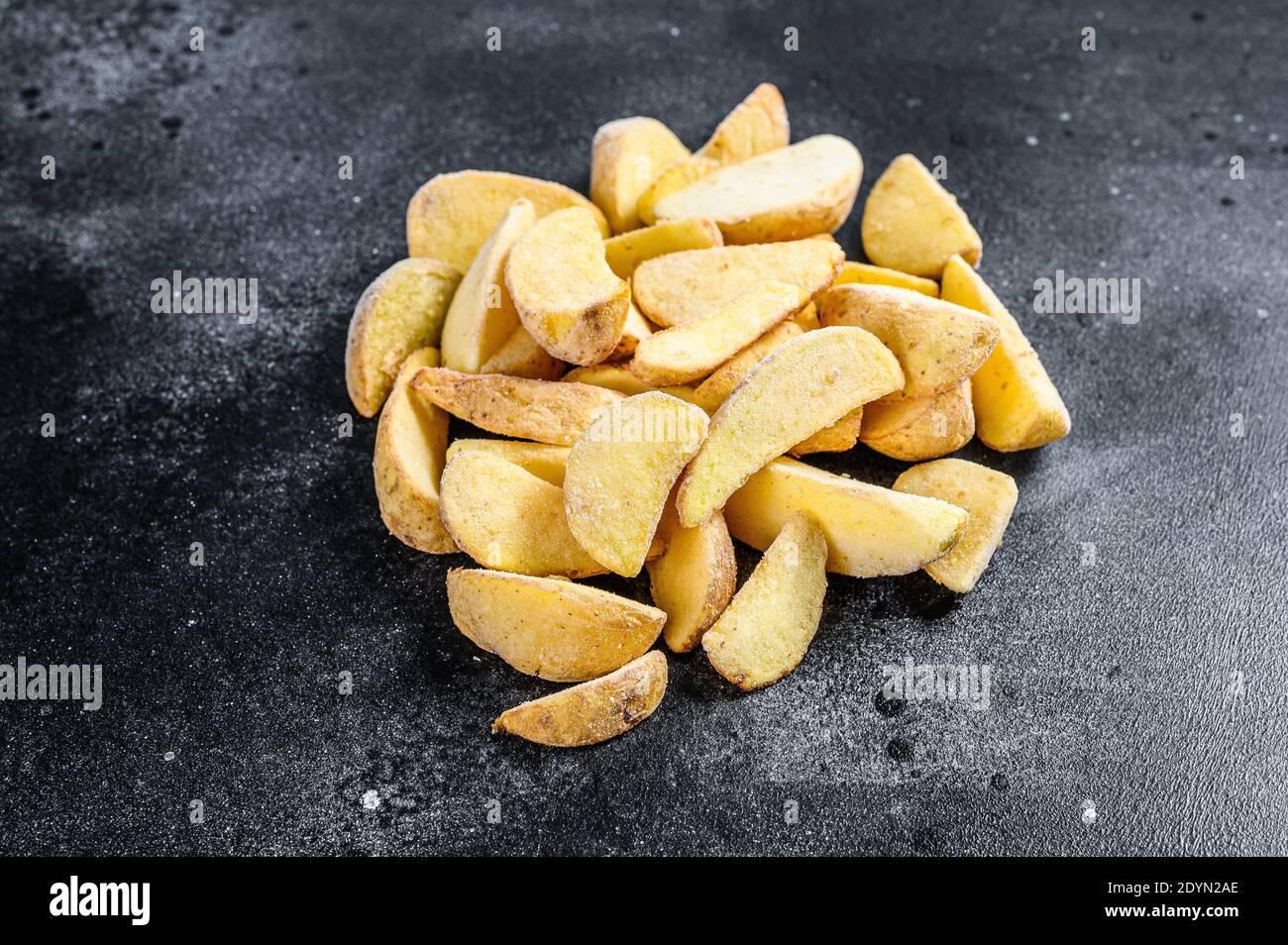frozen potato wedges. French fries. Black background. Top view Stock ...