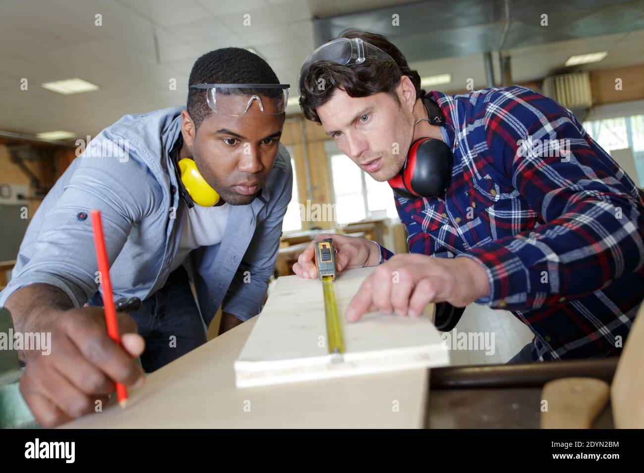 carpenter and apprentice working in studio Stock Photo - Alamy