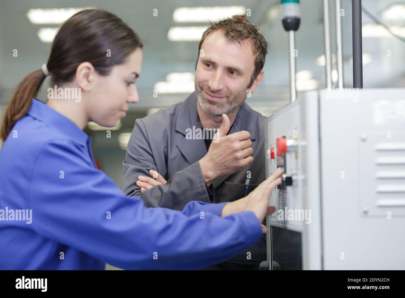 a machine operator taking with factory supervisor Stock Photo - Alamy