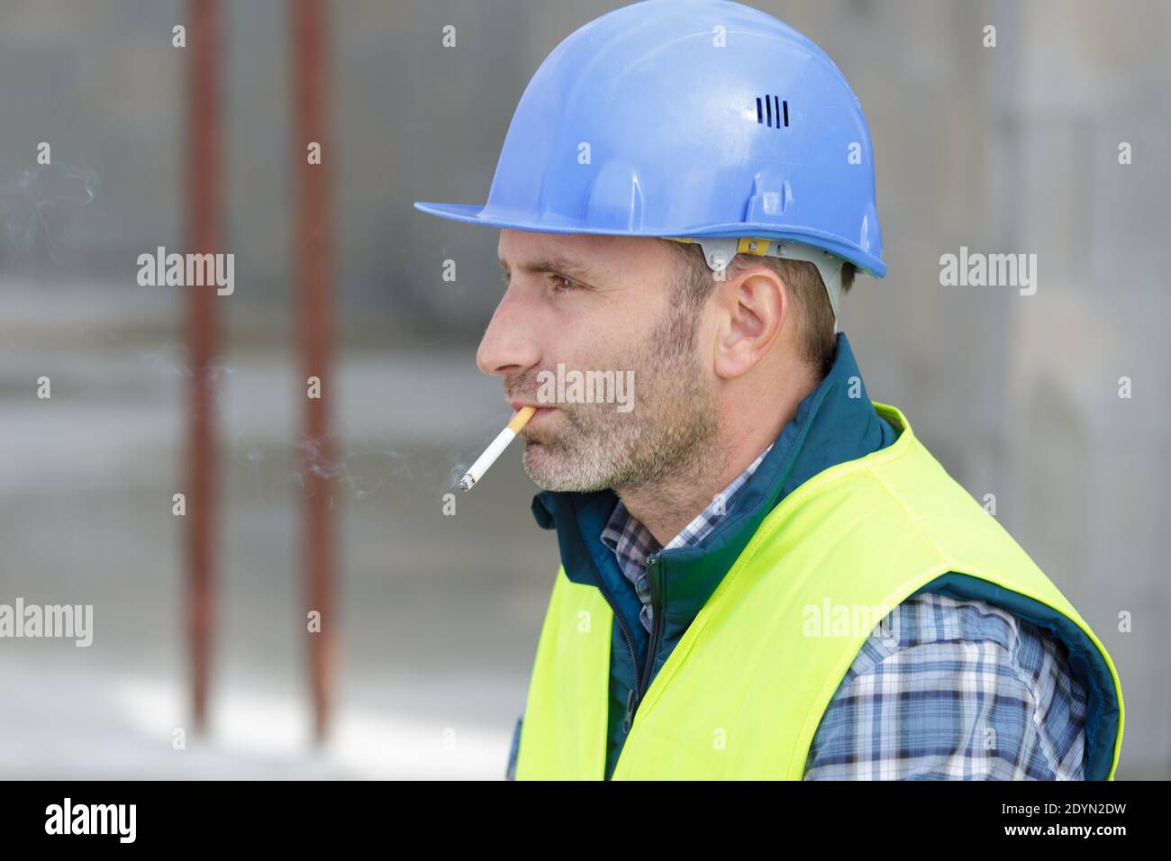 builder smoking cigarette on construction site Stock Photo - Alamy