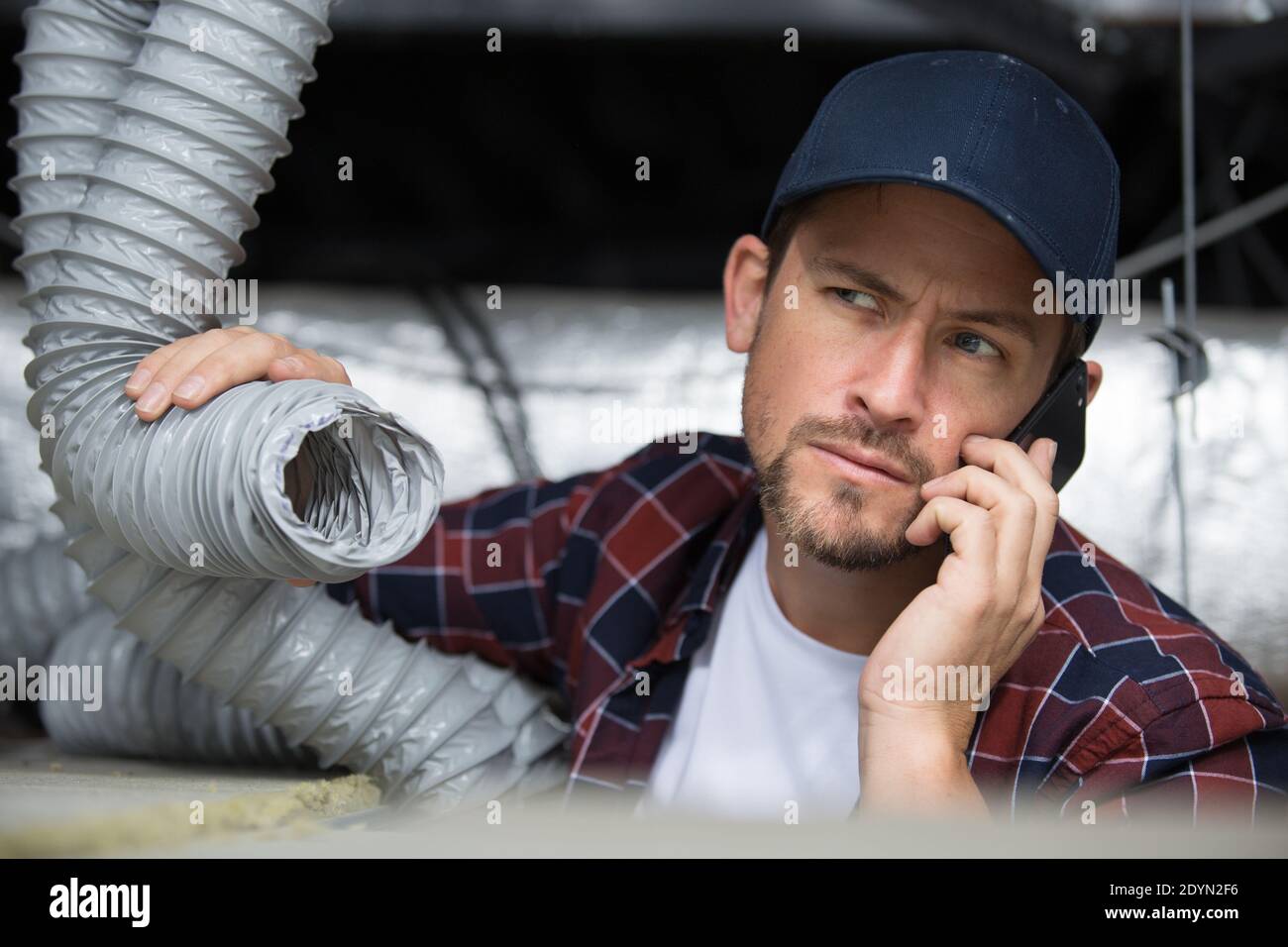 ventilation engineer taking call on smartphone Stock Photo - Alamy