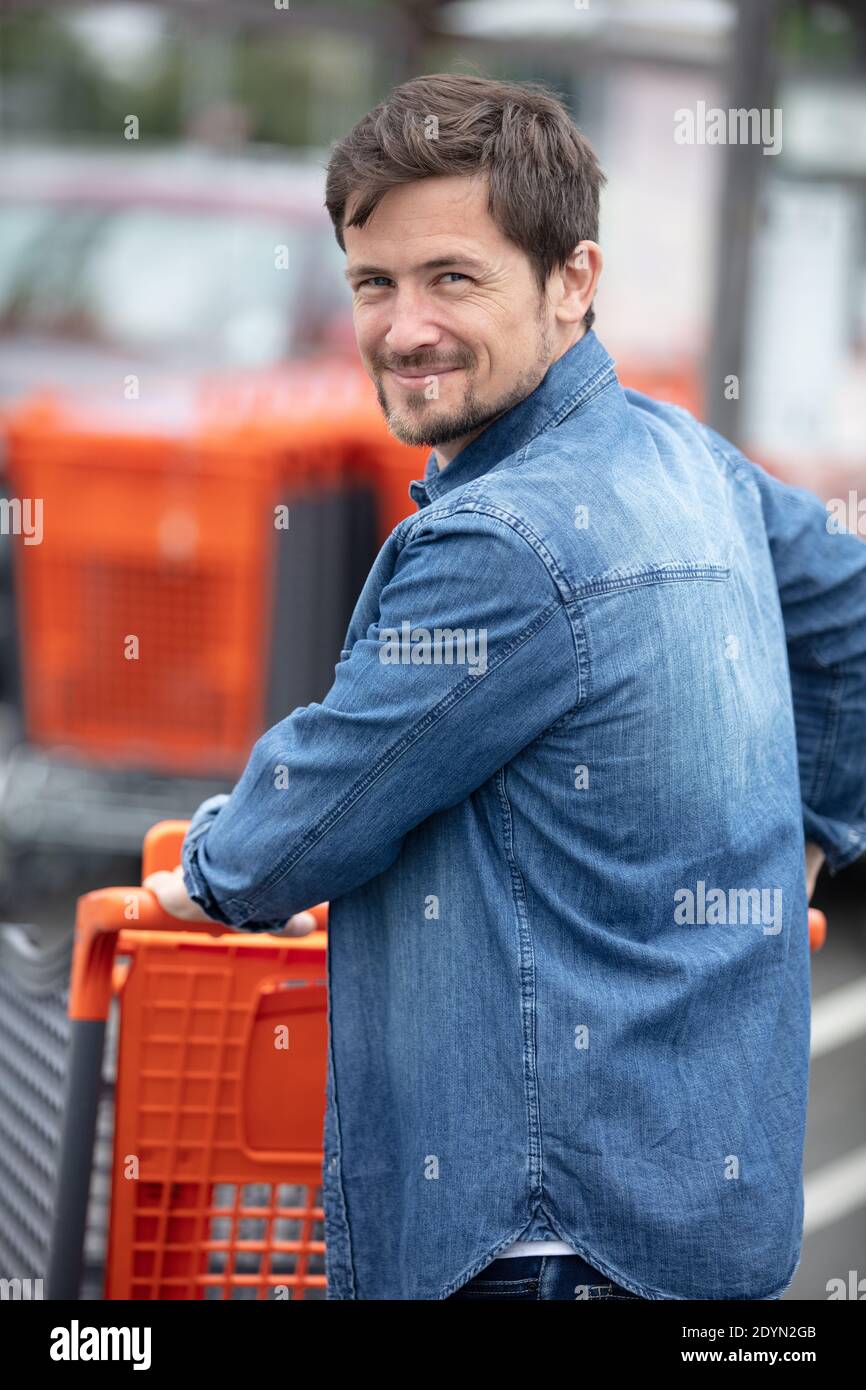 young man pushing a shopping cart Stock Photo - Alamy