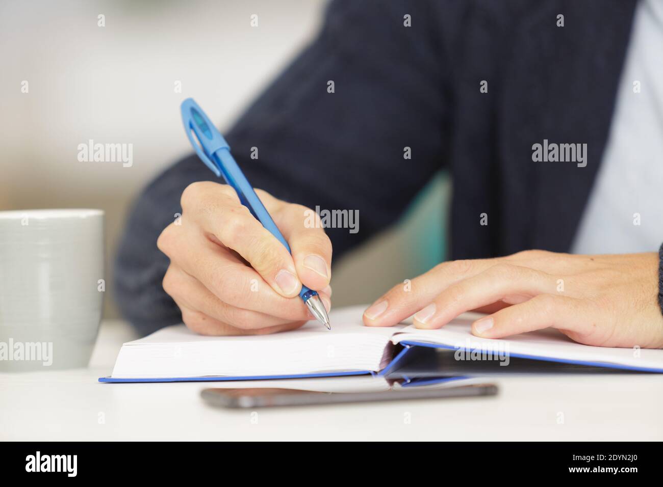 pen in man hand on white background Stock Photo - Alamy