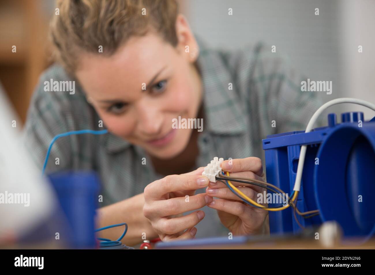 woman in electronics workshop connect wire Stock Photo - Alamy