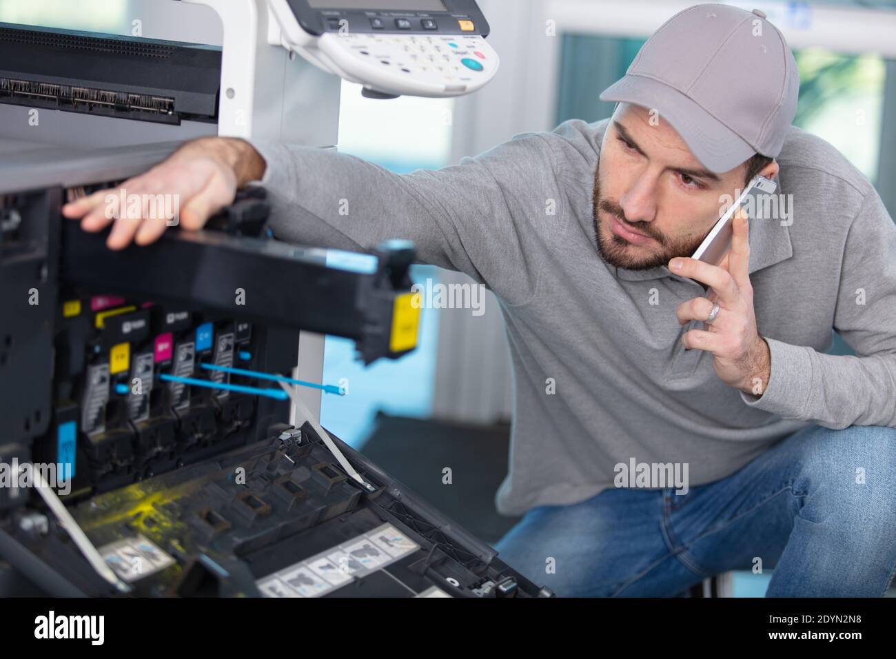 man technician repairing a printer at business place at work Stock ...