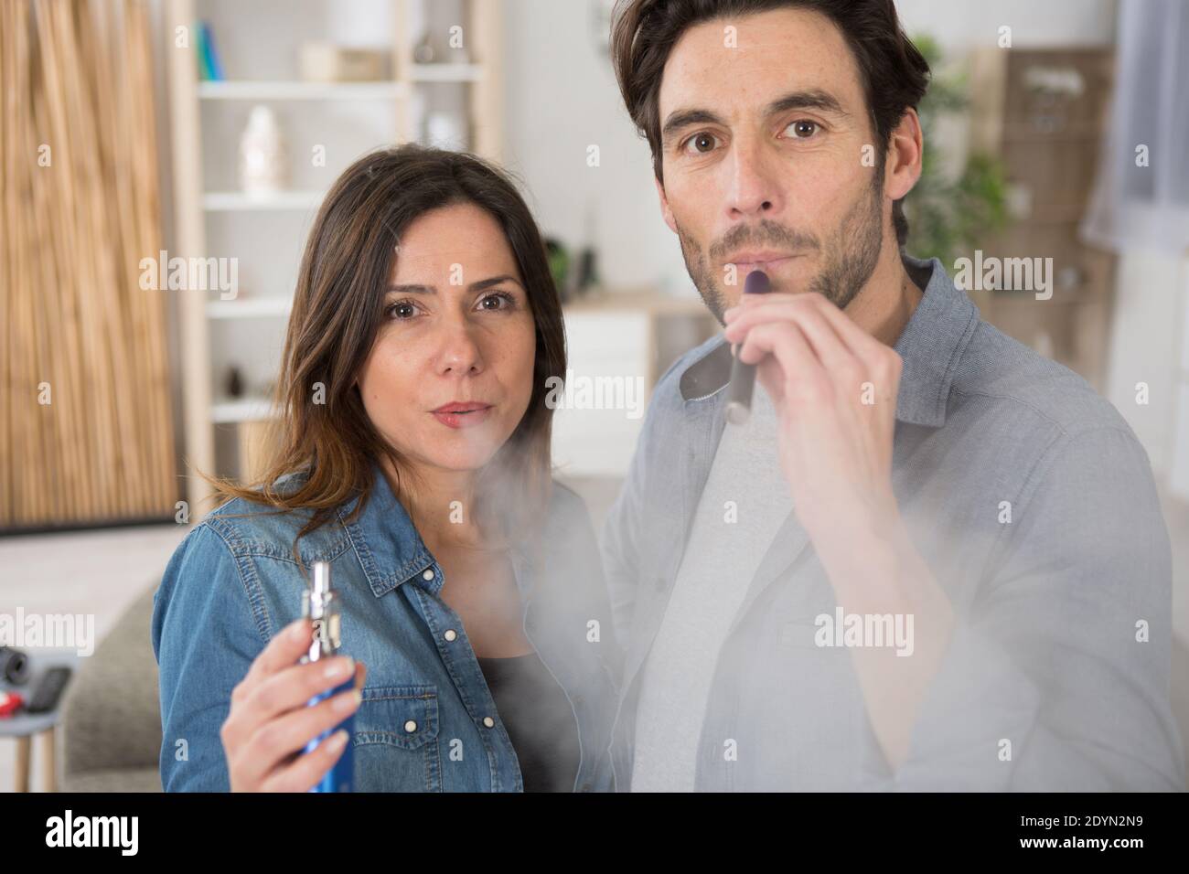 picture of couple vape smoking in the house Stock Photo - Alamy