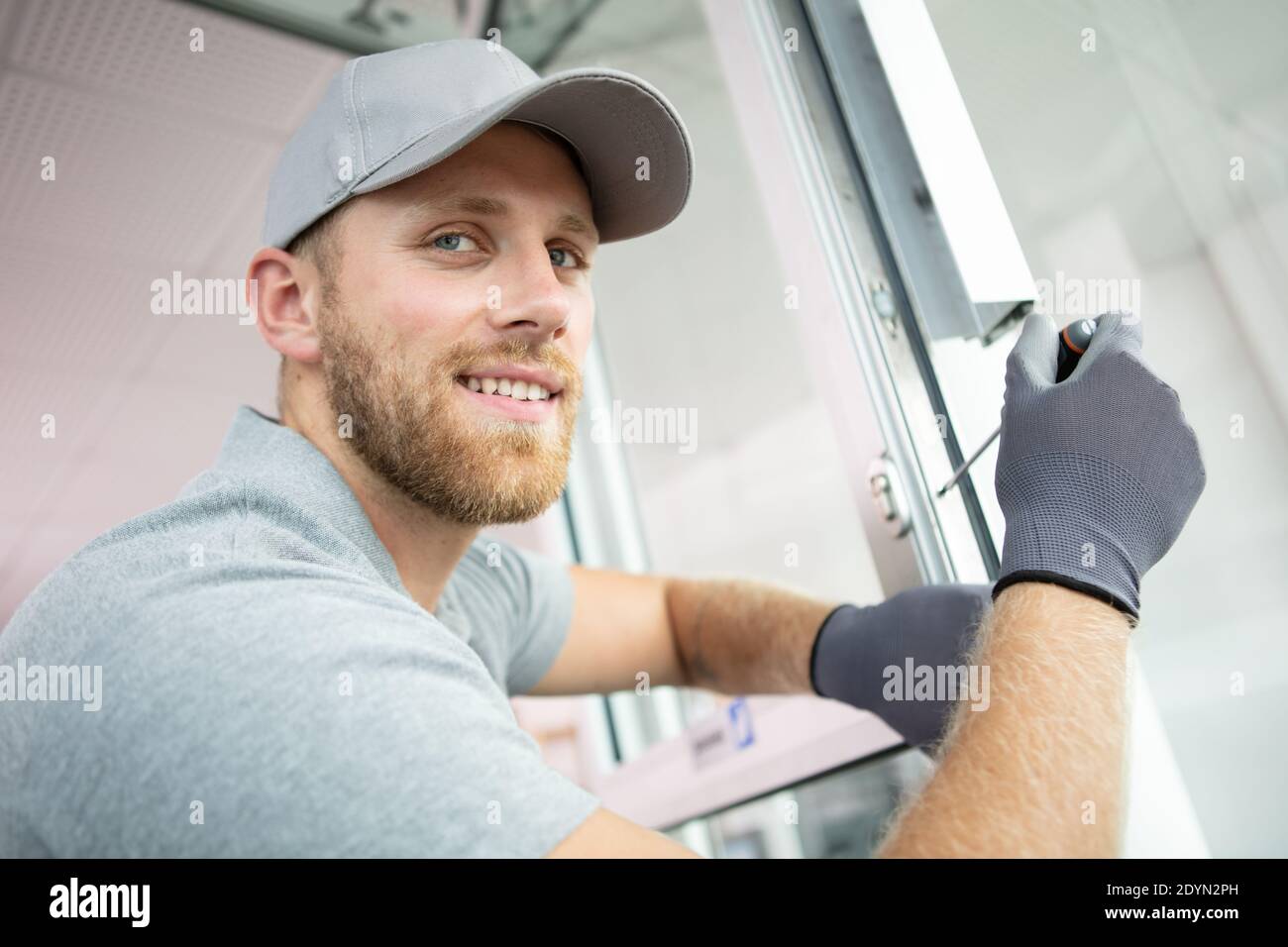 handyman using a cordless screwdriver to install a window Stock Photo ...