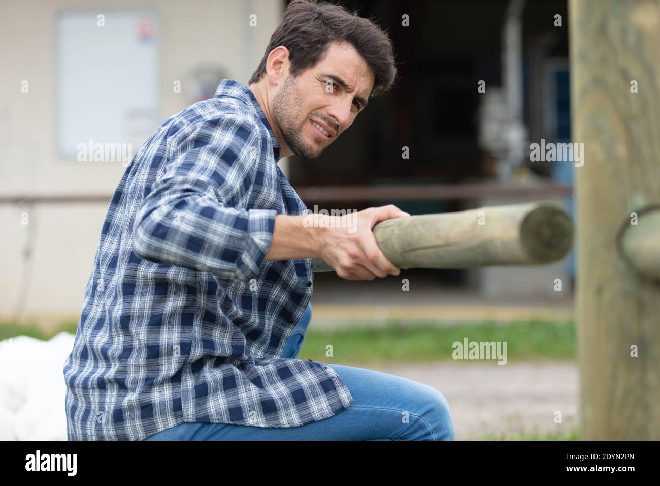 man with artificial heart strokes a wood fence Stock Photo - Alamy