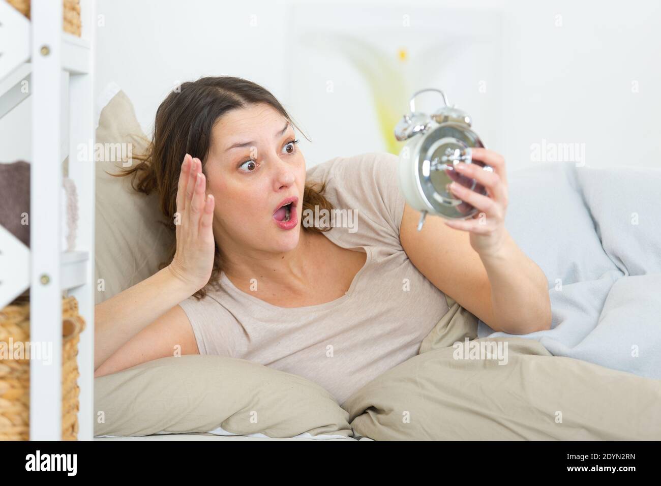 woman shocked she is waking up late Stock Photo - Alamy