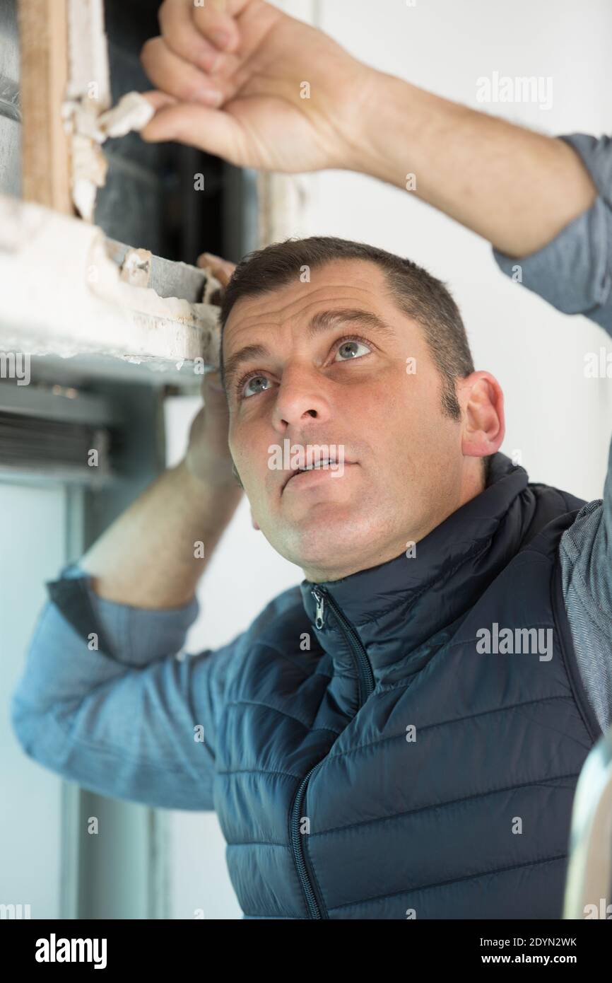 a man drilling window frame Stock Photo - Alamy