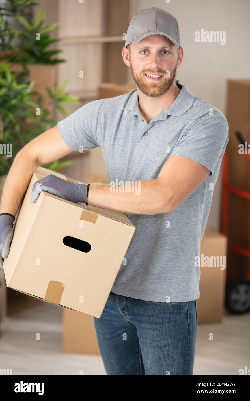male worker holding a cardboard box Stock Photo - Alamy