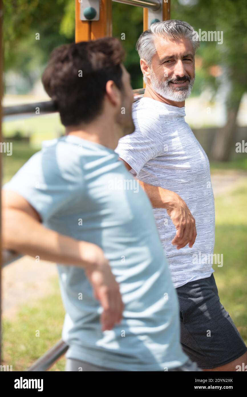 two man runners standing talking after running Stock Photo - Alamy