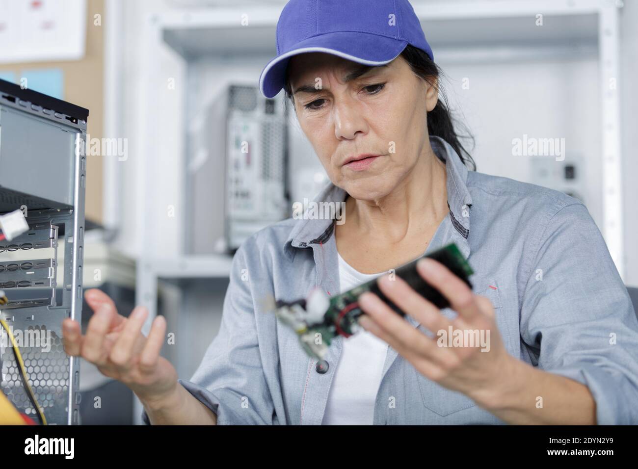 Pc engineer confused fixing hi-res stock photography and images - Alamy