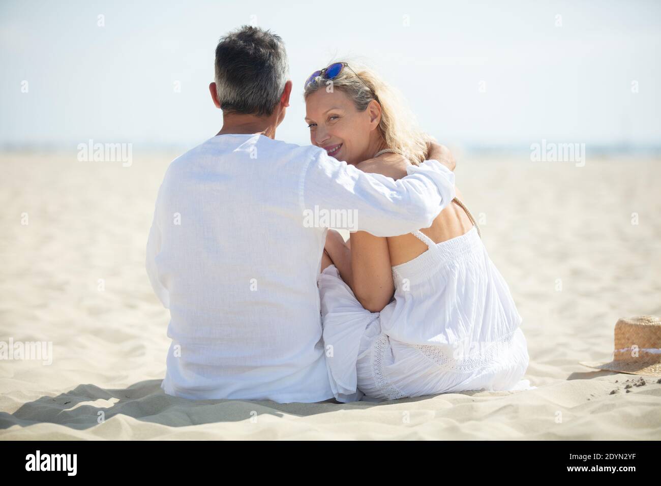 happy couple relaxing after exercise at the beach Stock Photo - Alamy