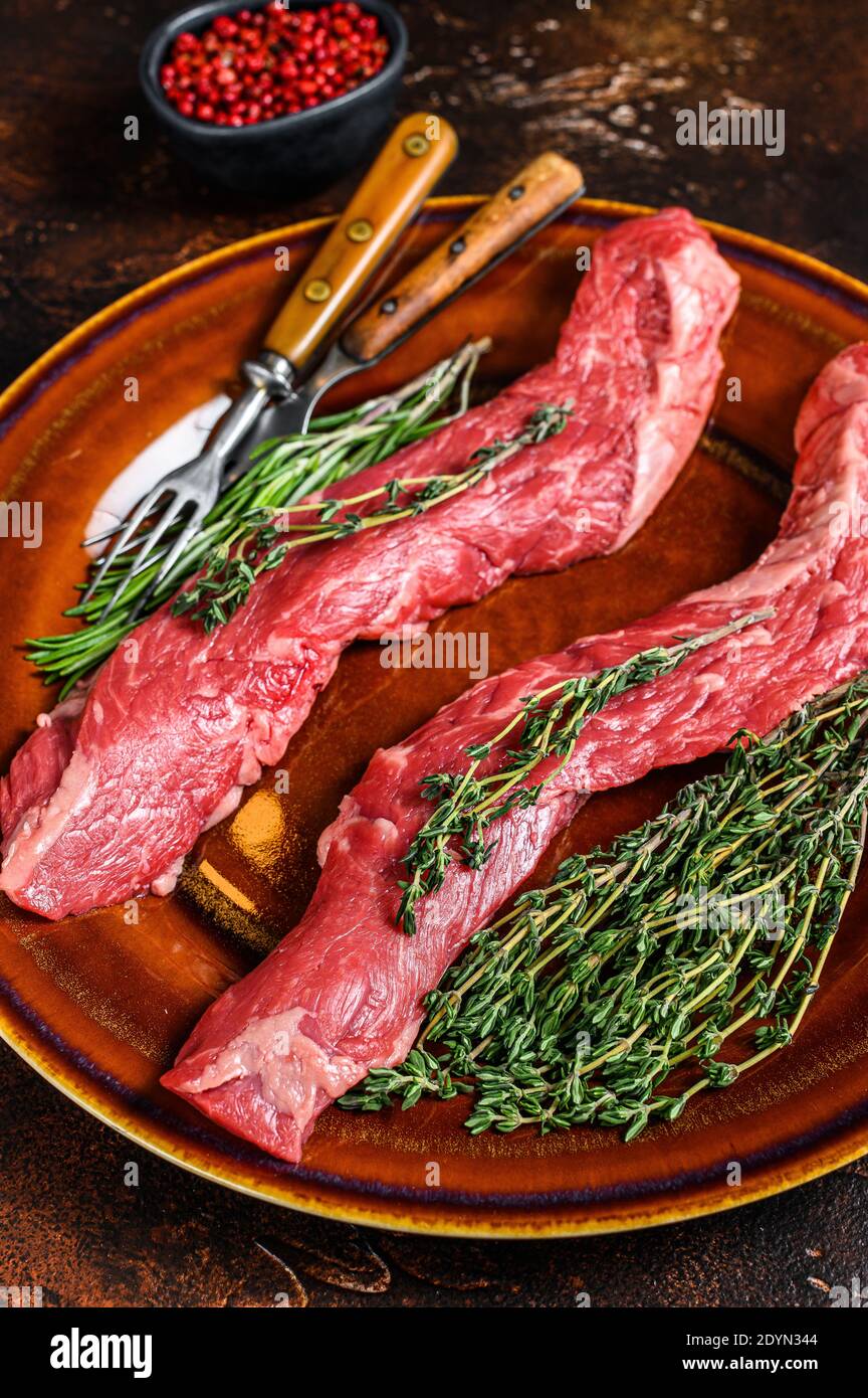 Raw flank beef meat steak on a plate. Dark background. Top view Stock ...