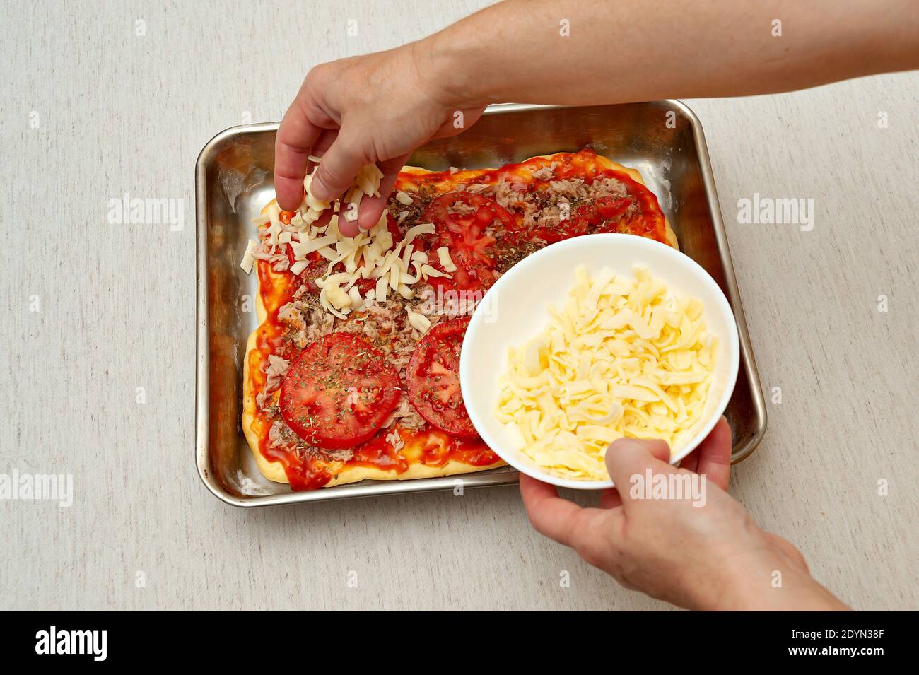 Putting mozzarella cheese on pizza hi-res stock photography and images ...