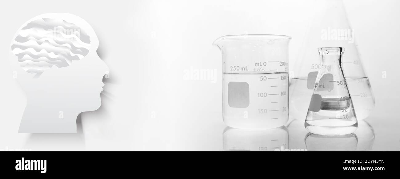 clear beaker and flask in science laboratory and graphic of human brain ...
