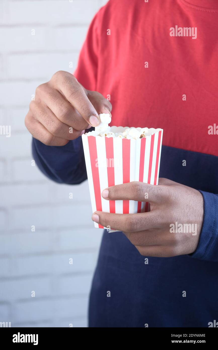 young man eating popcorn close up Stock Photo - Alamy