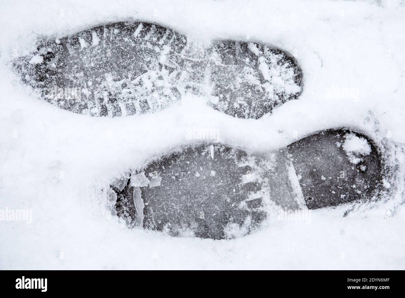 Footprints of he and she in the snow after sowfall. Mark of foot of two ...