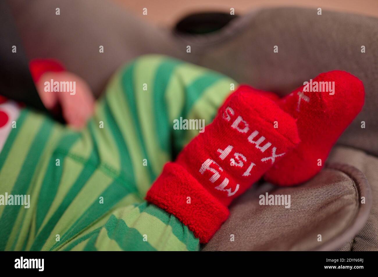 Newborn baby in Santa clothes lying in stroller - closeup of feet in ...