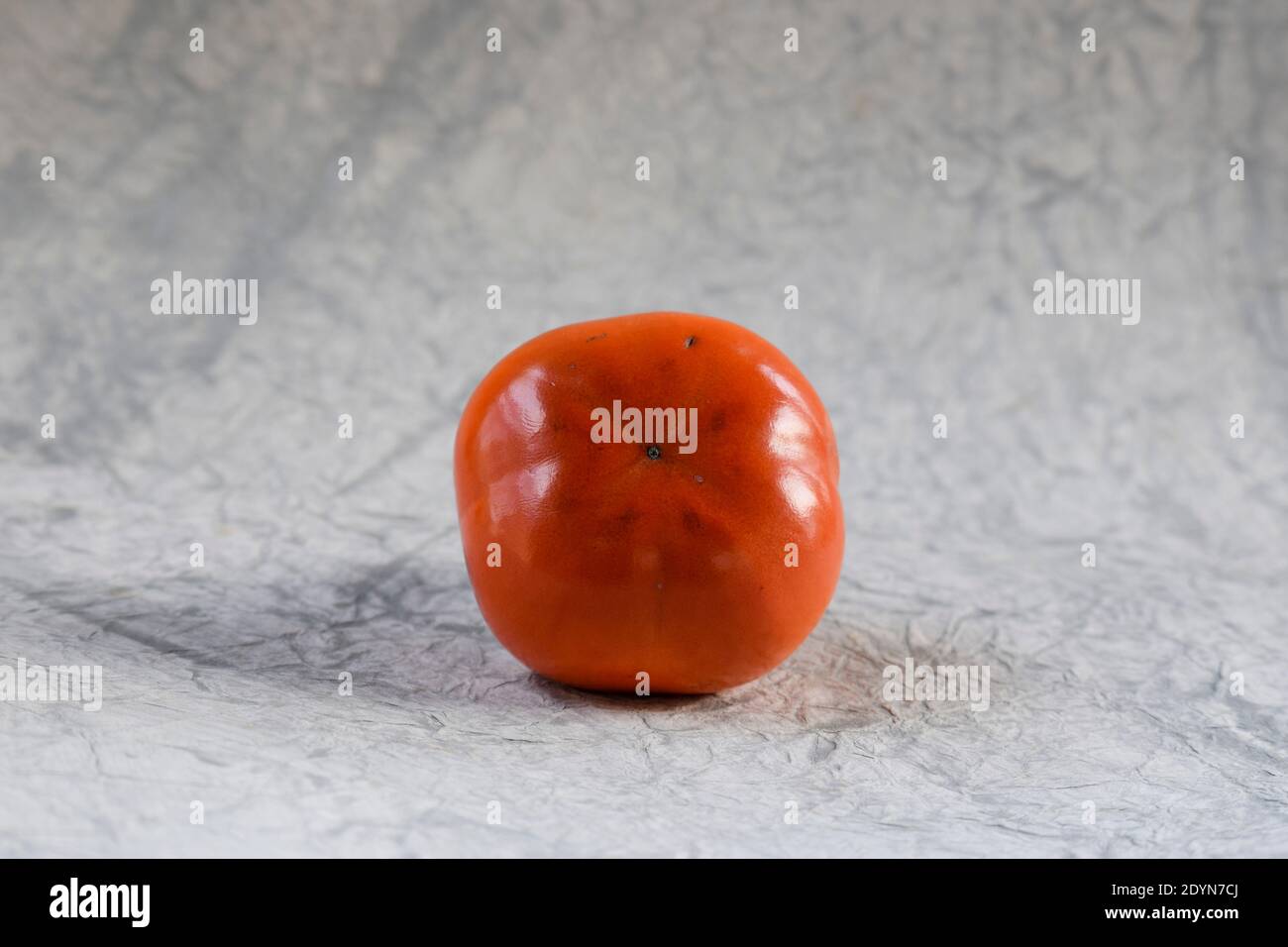 Back side of Persimmon fruit isolated with white background. Bright ...