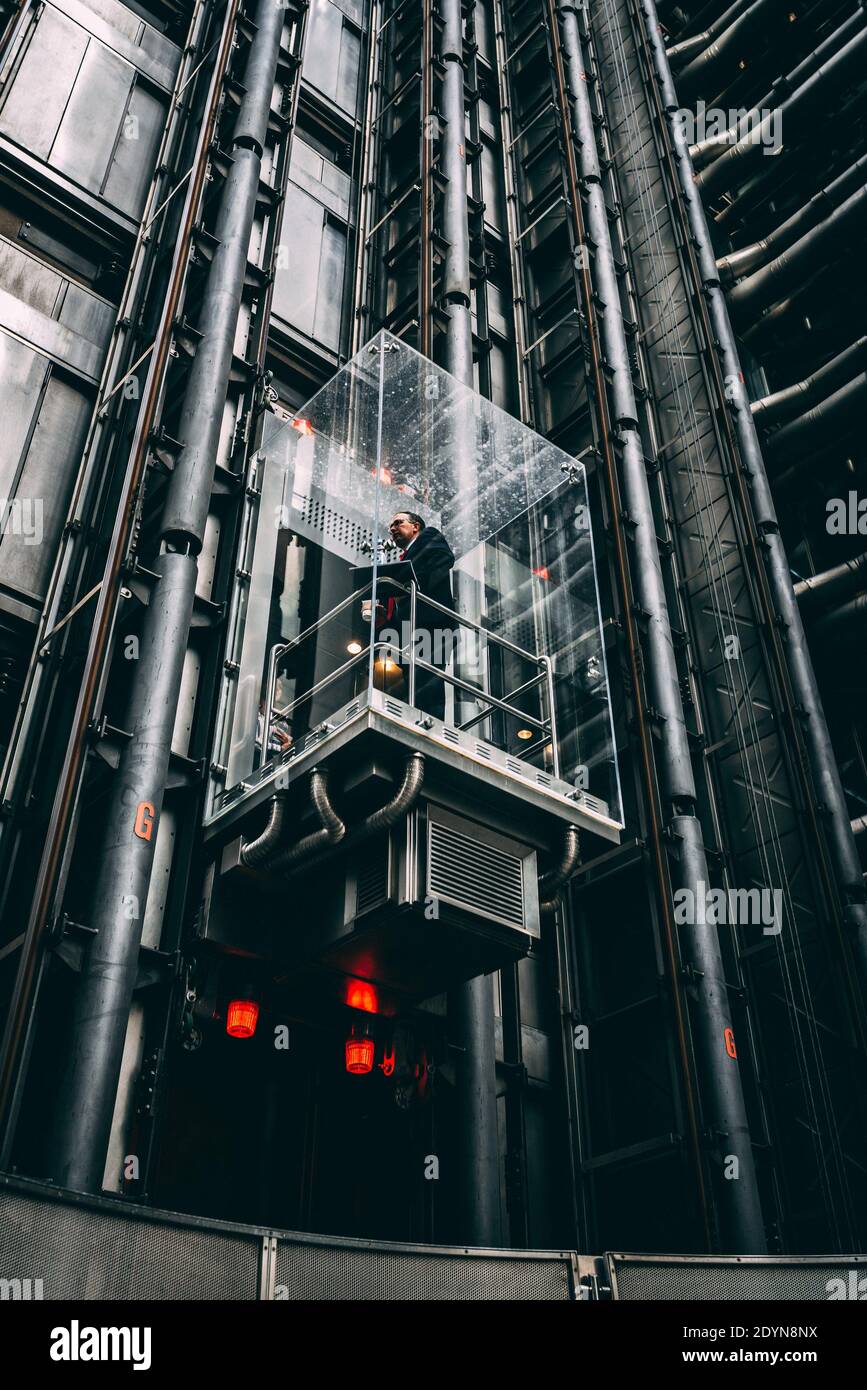 businessman in glass elevator going up Stock Photo - Alamy