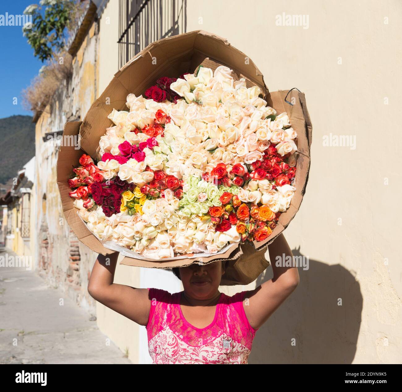 Antigua, Guatemala Indigenous woman holding up a large basket of ...