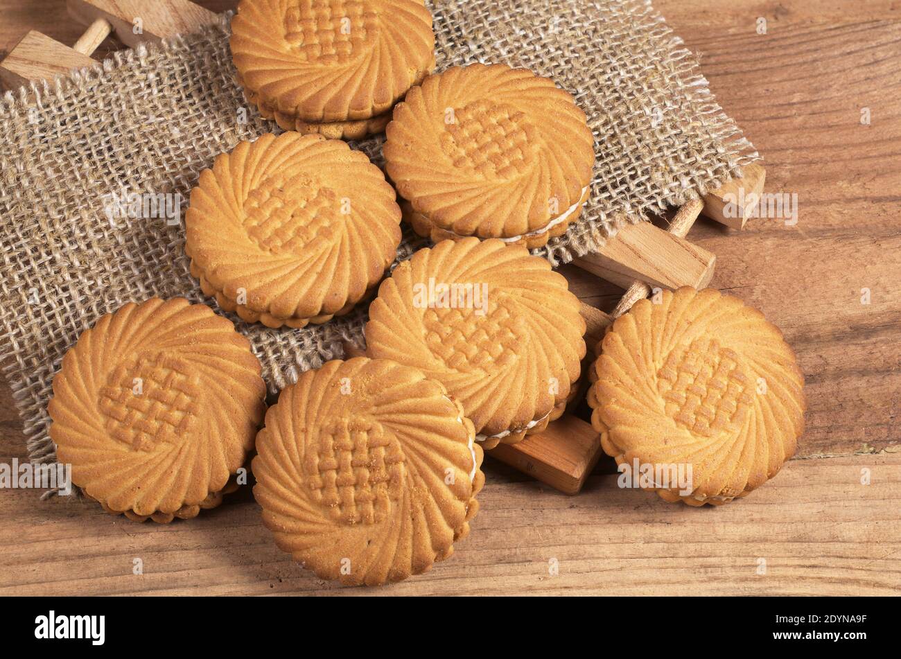 Cookie round with milk filling on old wooden table Stock Photo - Alamy